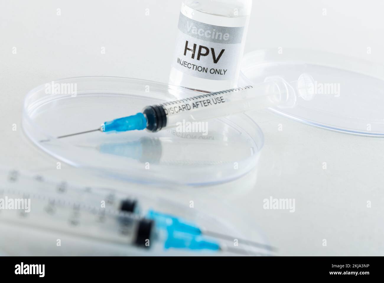 Composition of hpv vaccine vial and syringes on white background with ...