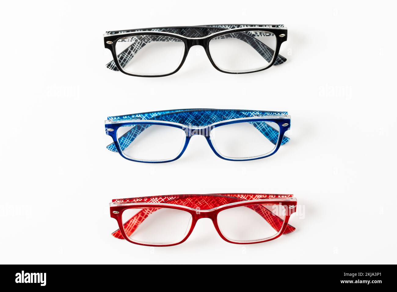 Composition of three pars of different colour glasses on white ...