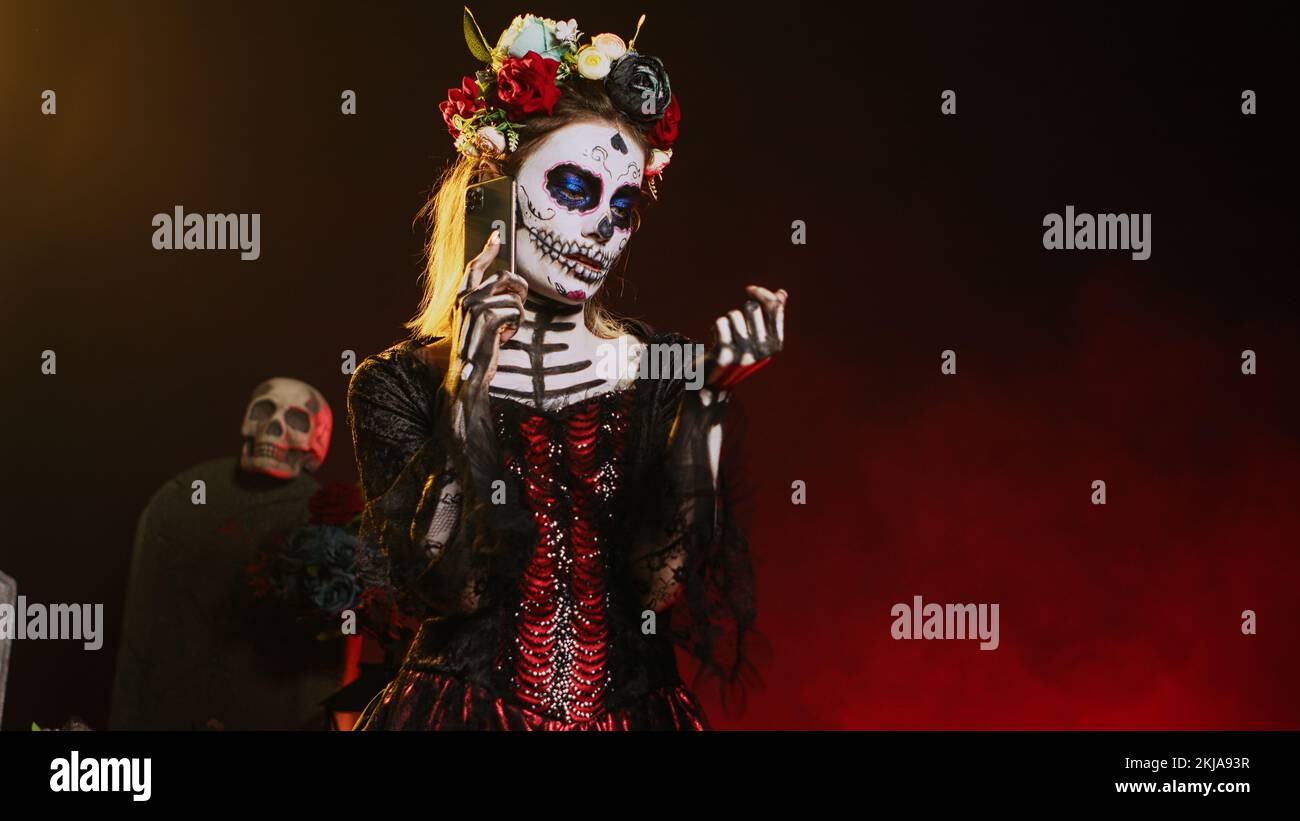 Spooky goddess talking on phone call with smartphone, wearing flowers ...