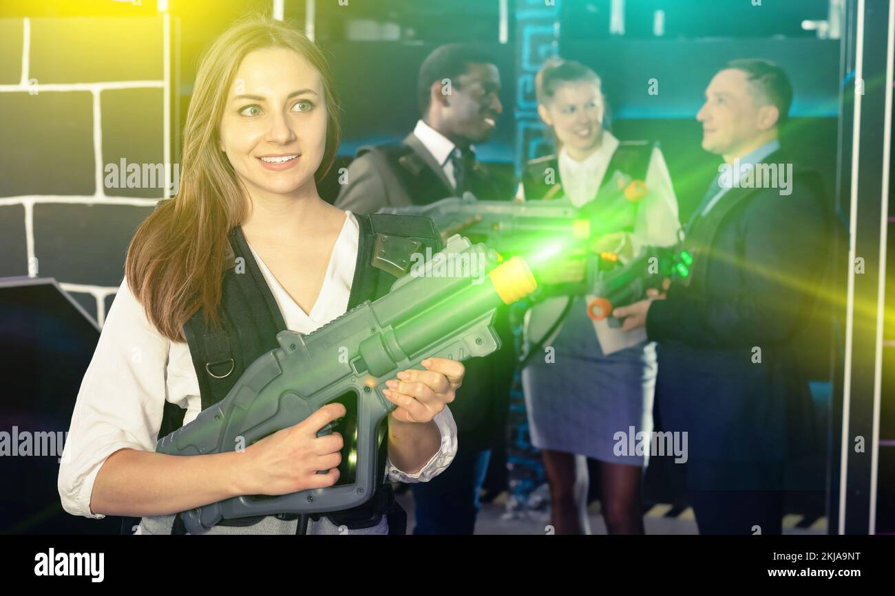 Woman holding laser gun and playing laser tag Stock Photo - Alamy