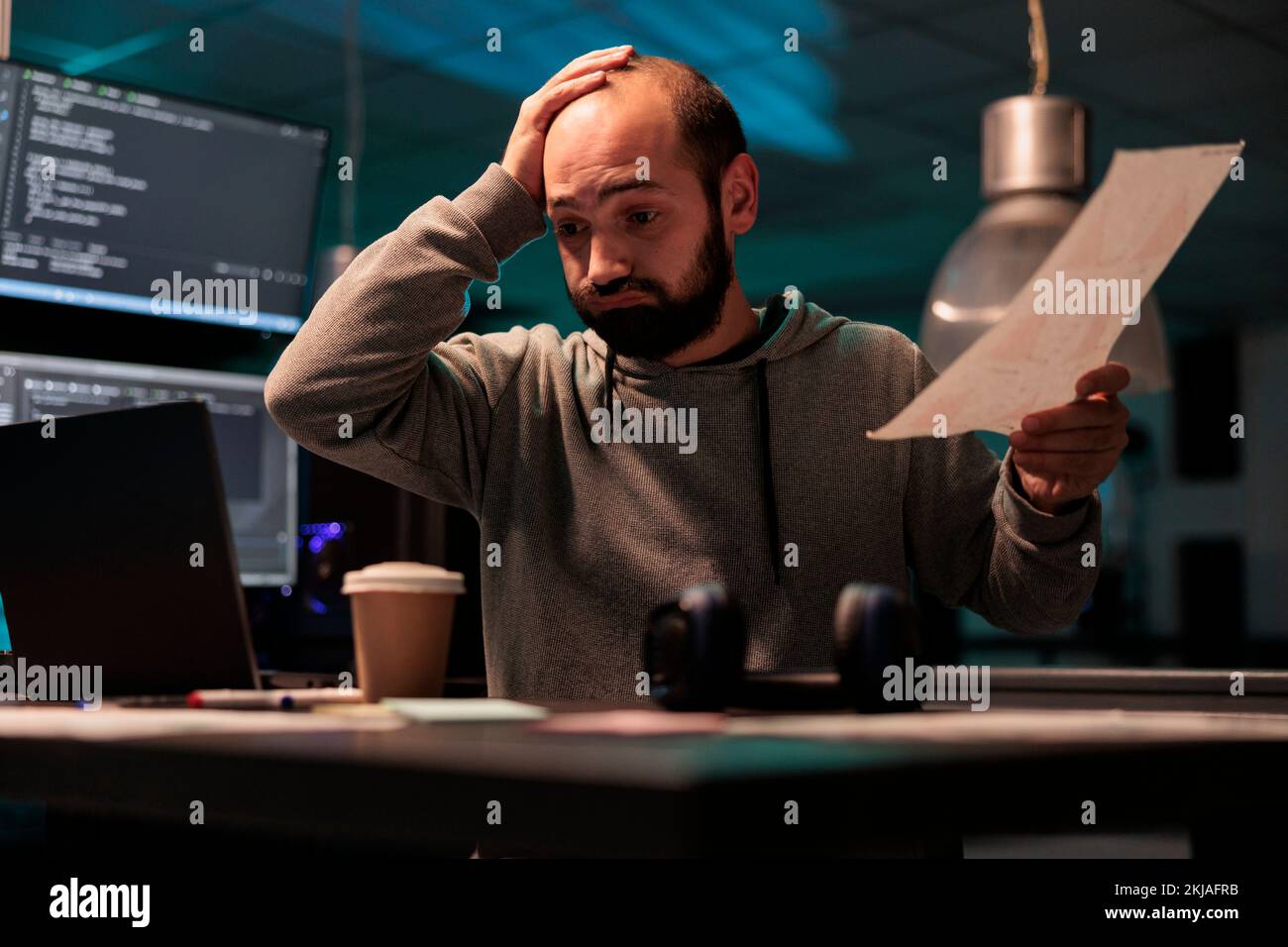 Tired software developer working late after hours, feeling under ... Tired software developer working late after hours, feeling under ...