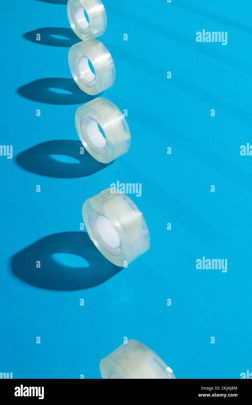 Rolls of transparent masking tape with copy space on blue background ...