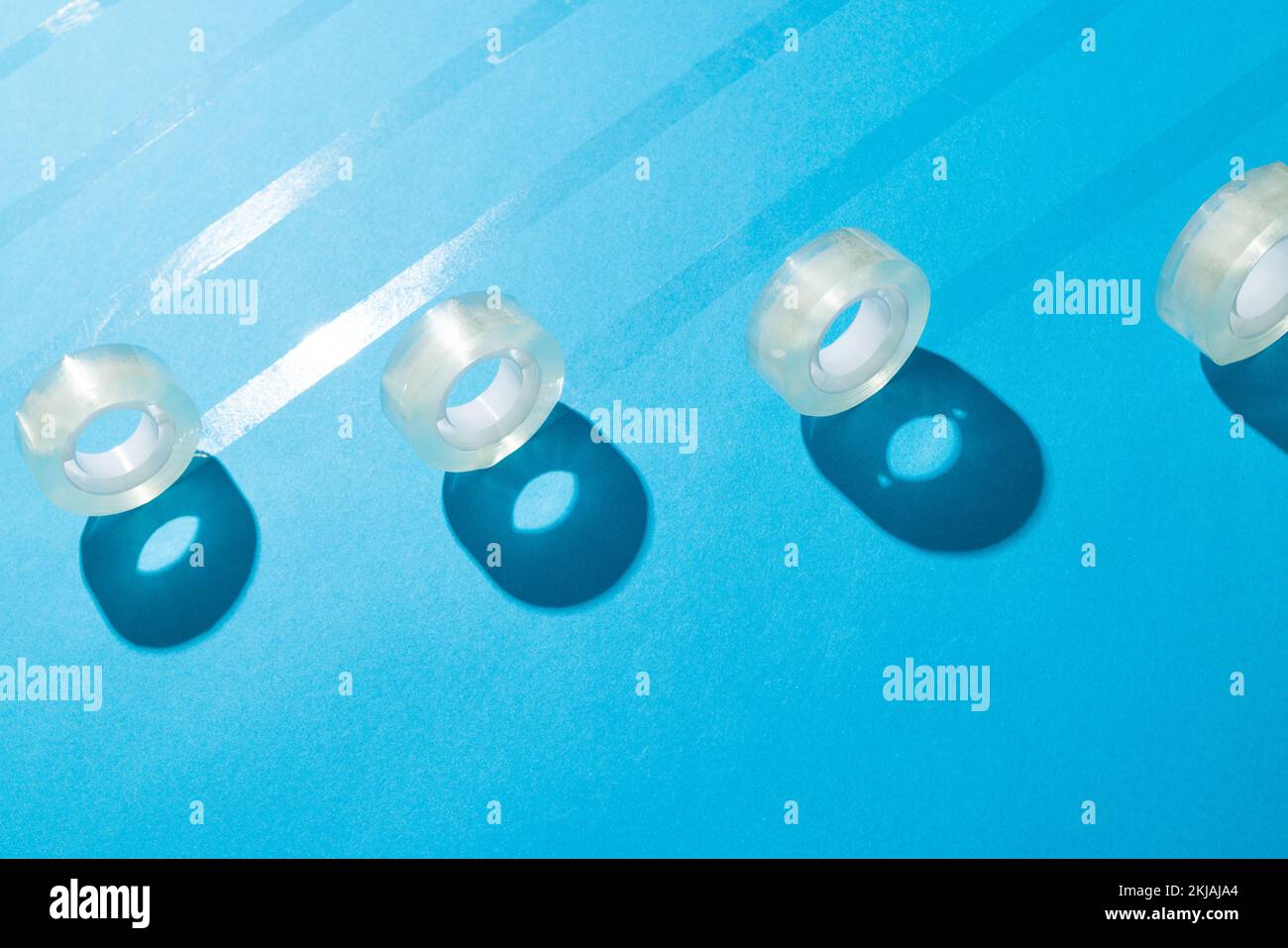 Rolls of transparent masking tape with copy space on blue background ...