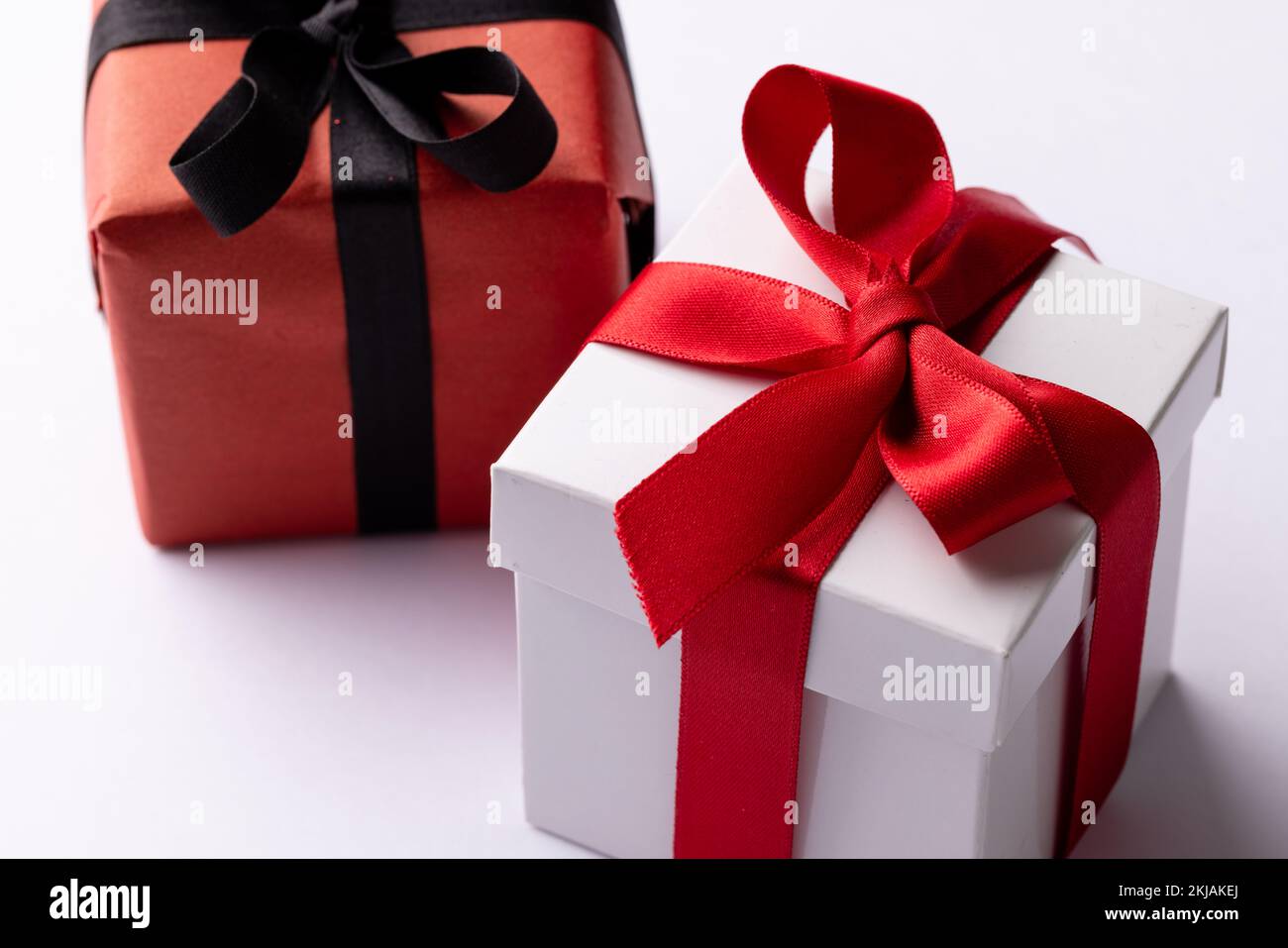 White and red gifts with red and black ribbons, on white background ...