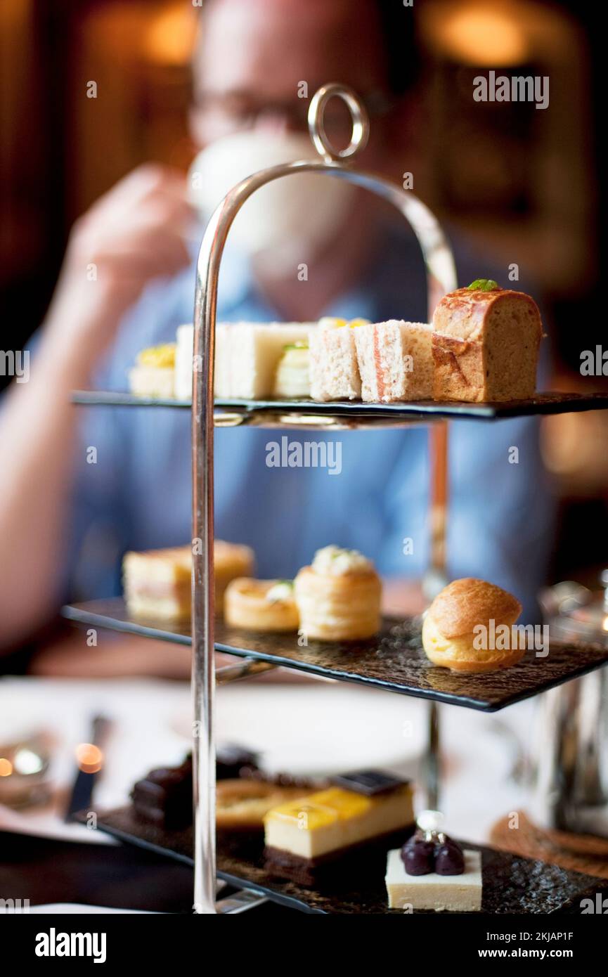A three-tiered tea tray of savoury and sweet treats at Hullett House ...