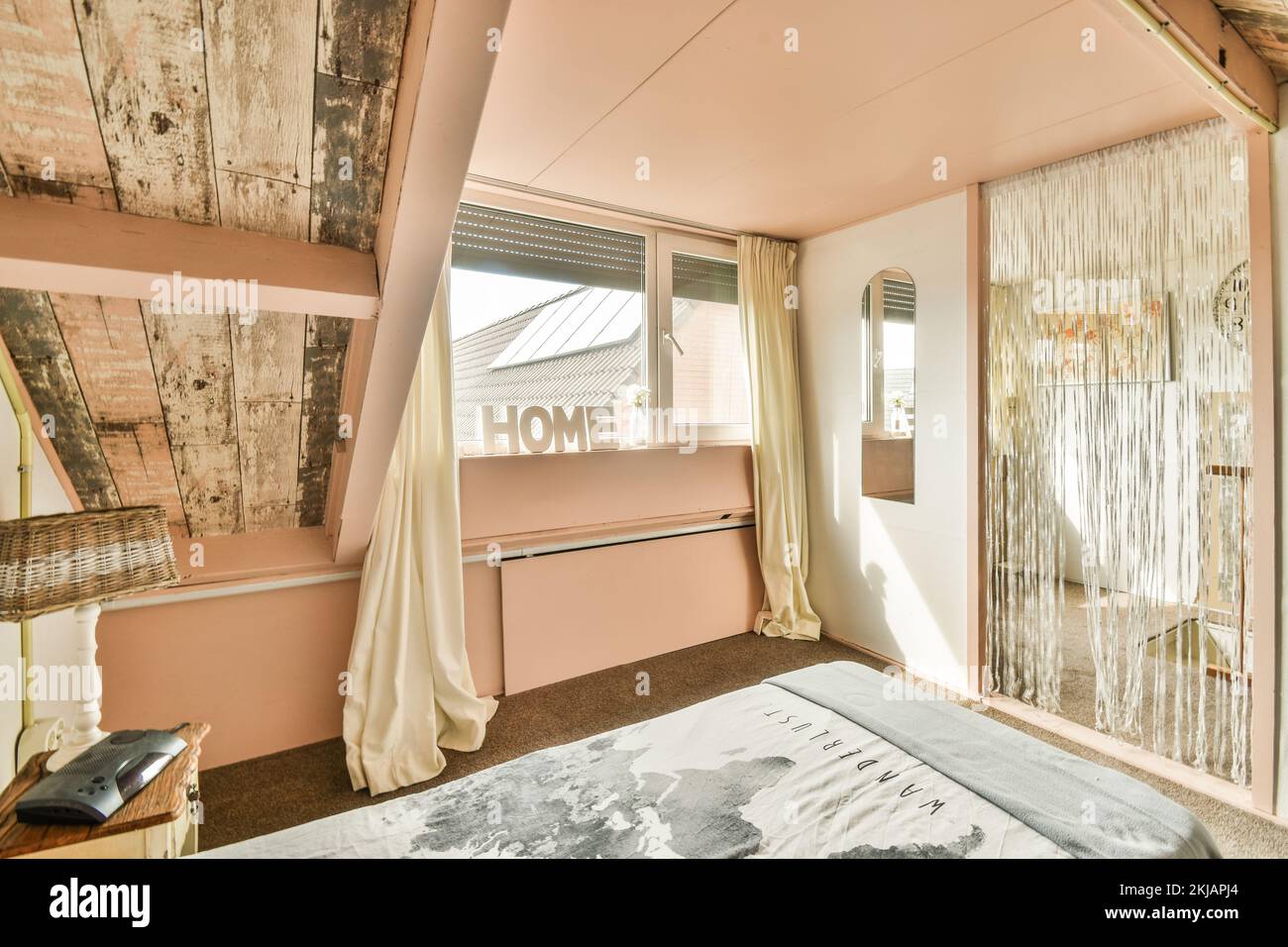 Interior of mansard kid bedroom with bed with various toys at home ...