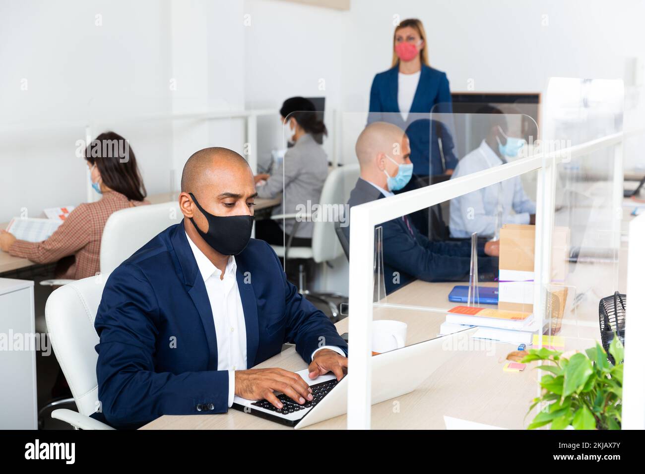 positive latino male manager in white office during epidemic Stock ...