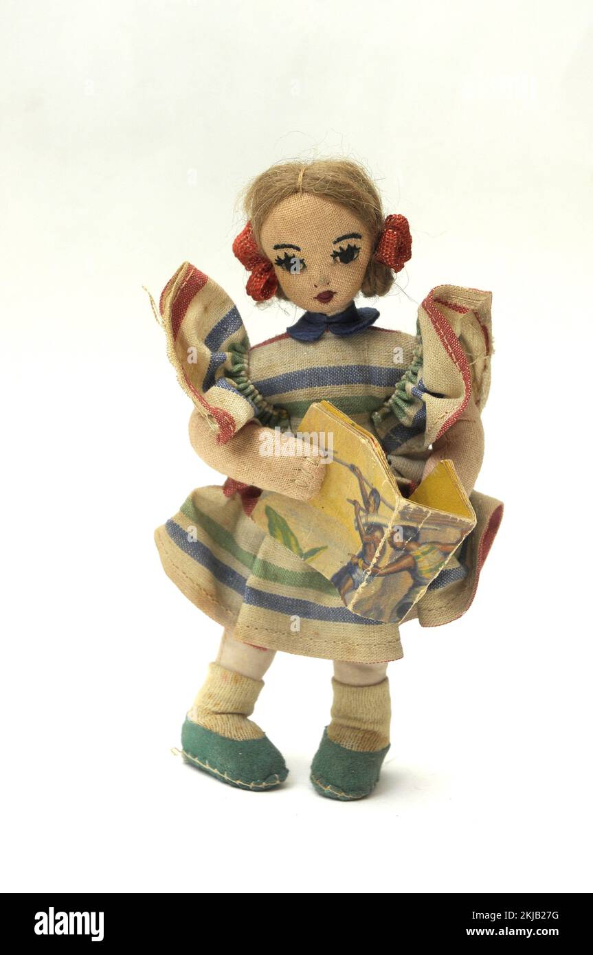 white girl doll reading a book of Africans Stock Photo - Alamy