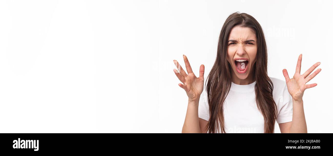 Close-up portrait of angry, pissed-off aggressive woman screaming at ...