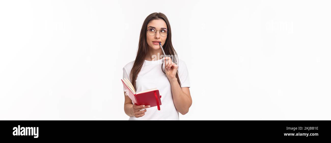 Portrait of creative and thoughtful gorgeous young woman making plans ...