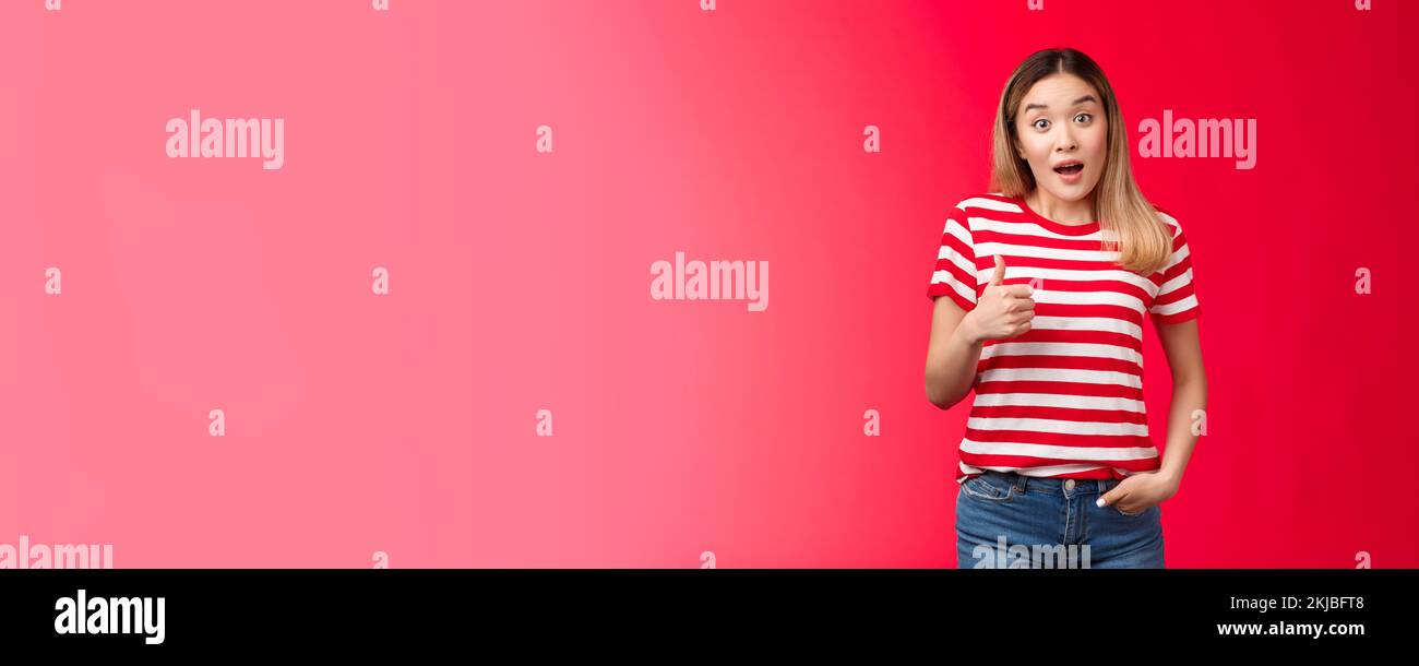 Surprised impressed asian blond girl judge good performance give thumb ...