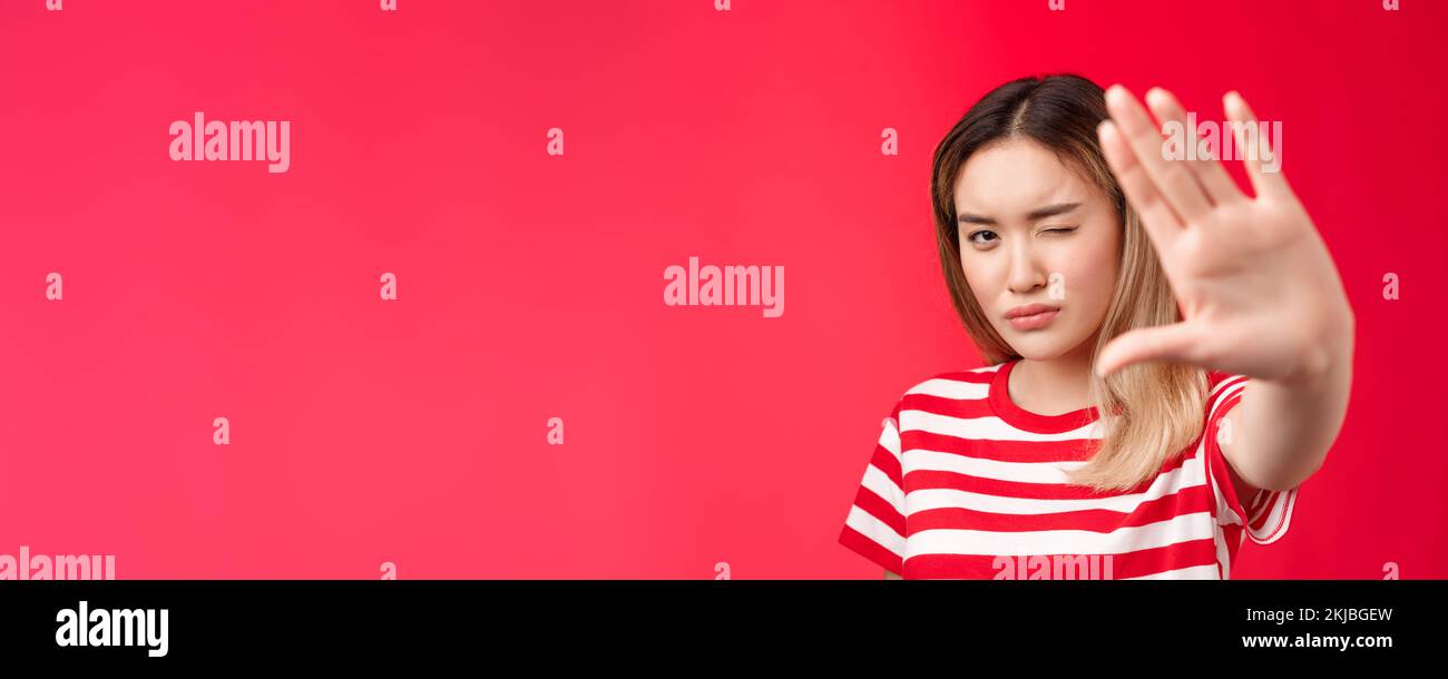 Close-up serious-looking determined asian blond woman pull hand forward ...