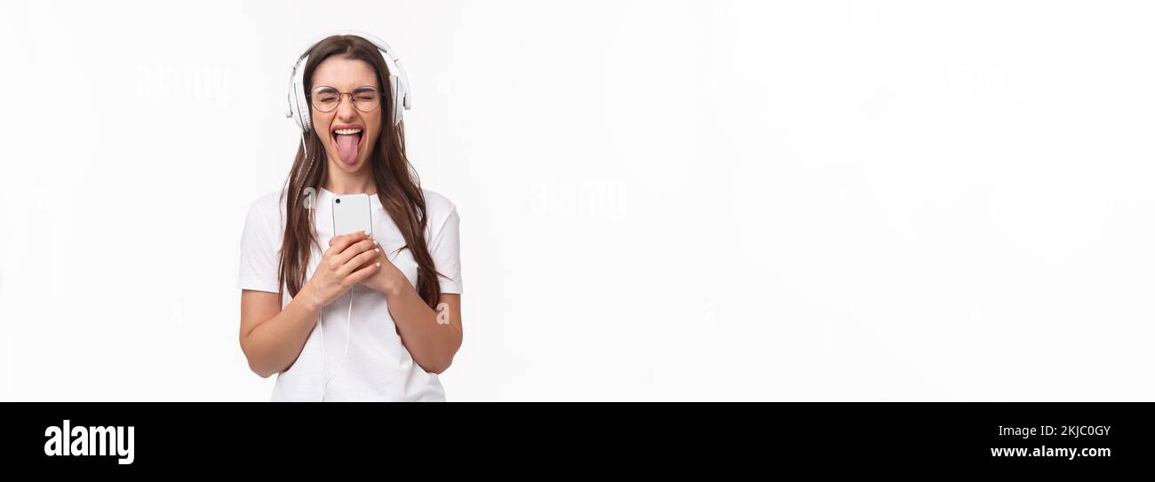 Technology, lifestyle and music concept. Portrait of carefree happy and ...
