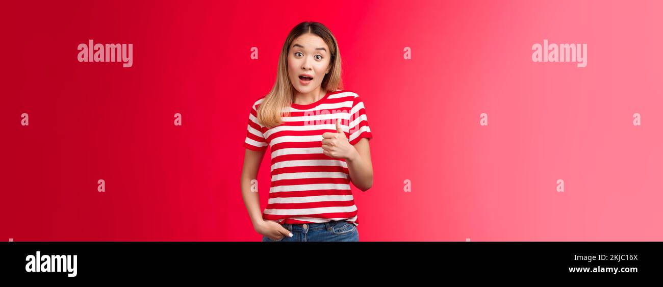 Surprised impressed asian blond girl judge good performance give thumb ...