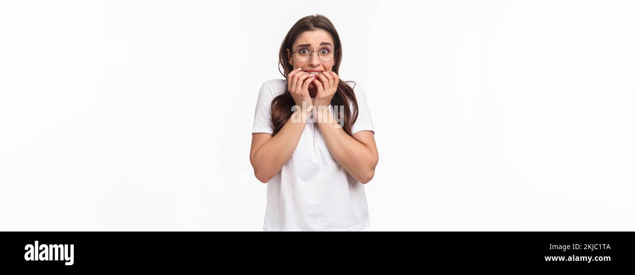 Waist-up portrait of scared young brunette girl in panic, exams are ...