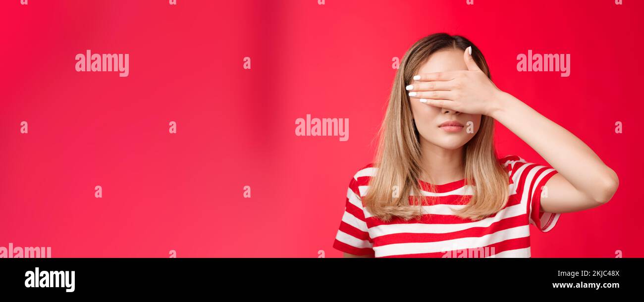 Serious-looking intense asian woman cover sight, hold palm on eyes ...