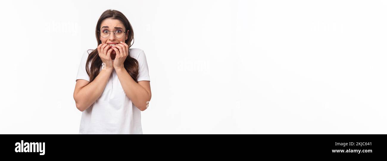 Waist-up portrait of scared young brunette girl in panic, exams are ...