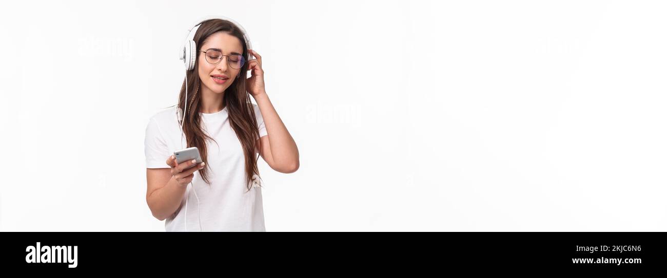 Technology, lifestyle and music concept. Portrait of pleased and ...