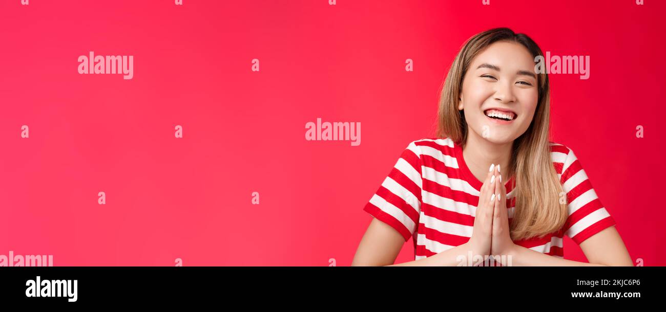 Close-up cheerful carefree laughing cute asian girl hold hands pray ...