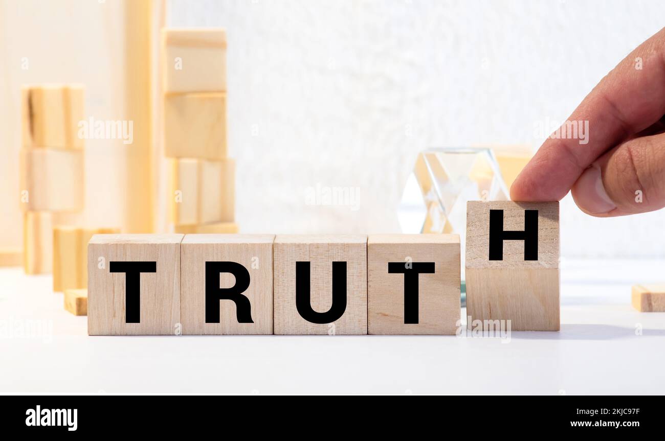 Hand turned wood cube and changes the word Trust to Truth Stock Photo ...