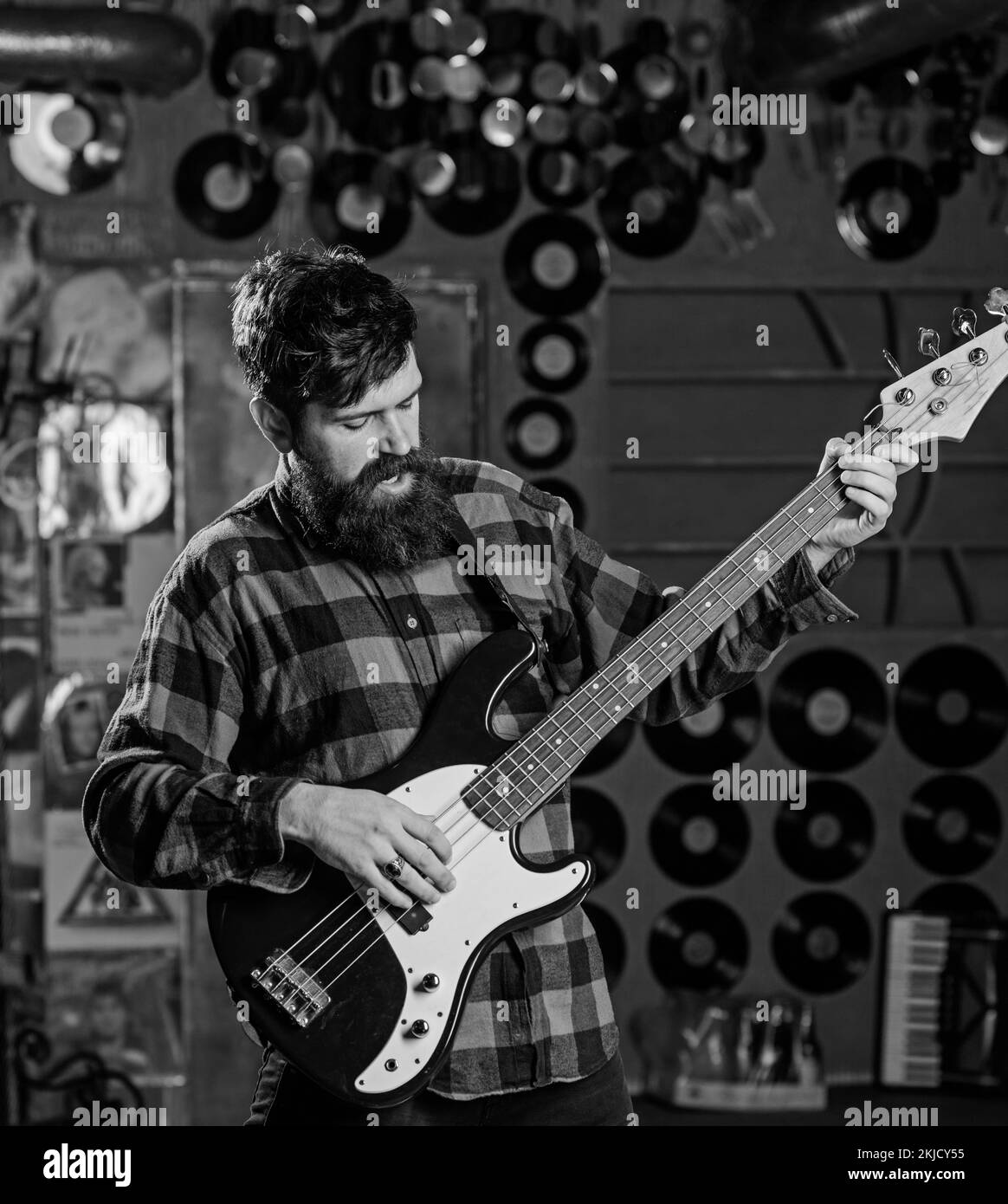 Bassist concept. Man s holds bass guitar, play music in club atmosphere ...