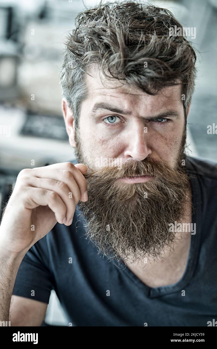 Hipster brutal guy twisting mustache. Man confident brutal bearded ...