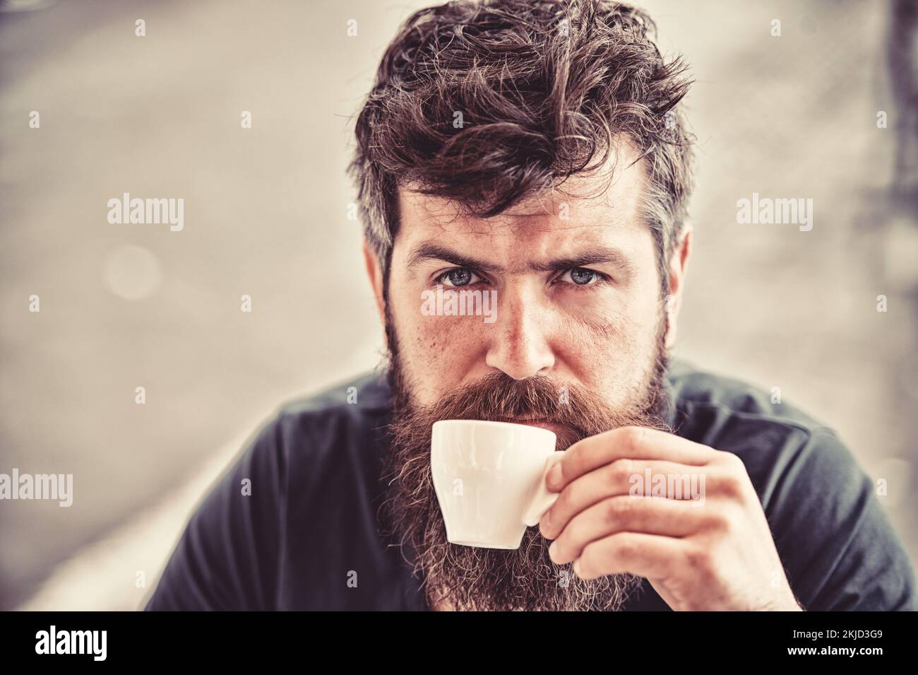 Coffee break concept. Man with long beard looks calm and relaxed ...