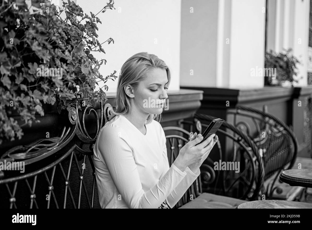 Keep in touch. Woman calm face texting smartphone cafe terrace urban ...