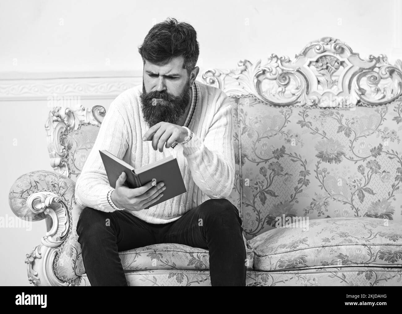 Macho on concentrated face reading book. Scandalous bestseller concept ...