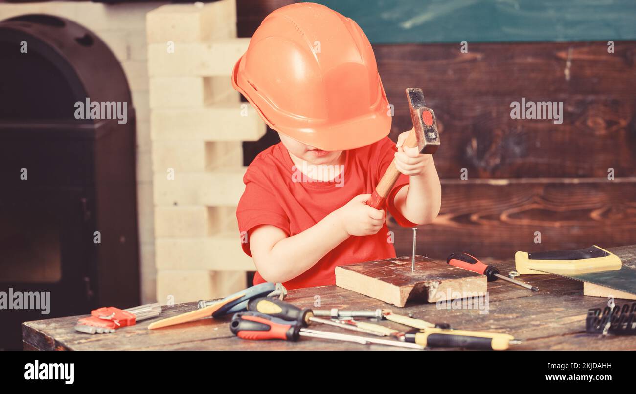 Little repairman in workshop. Protective helmet hiding boys face. Kid ...