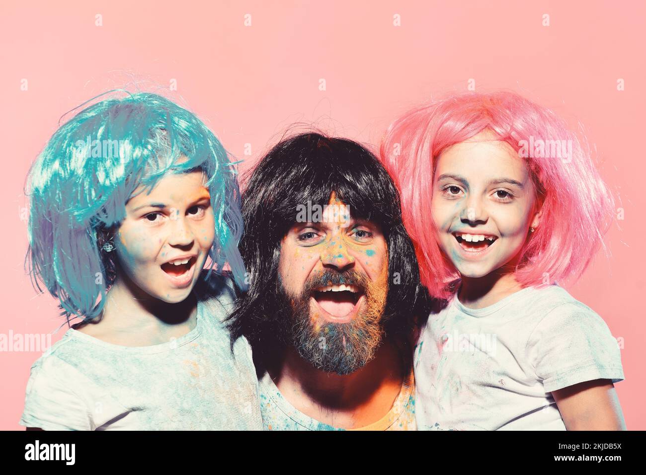 Kids and bearded man wear wigs. Art and fun concept Stock Photo - Alamy
