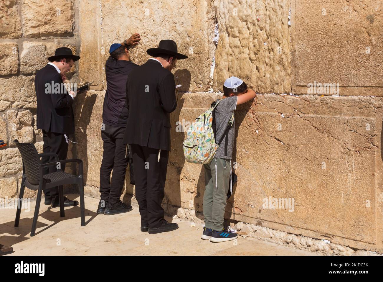 Jewish orthodox men and boy praying at the Western Wall Plaza or Wailing Wall, Jewish Quarter ...