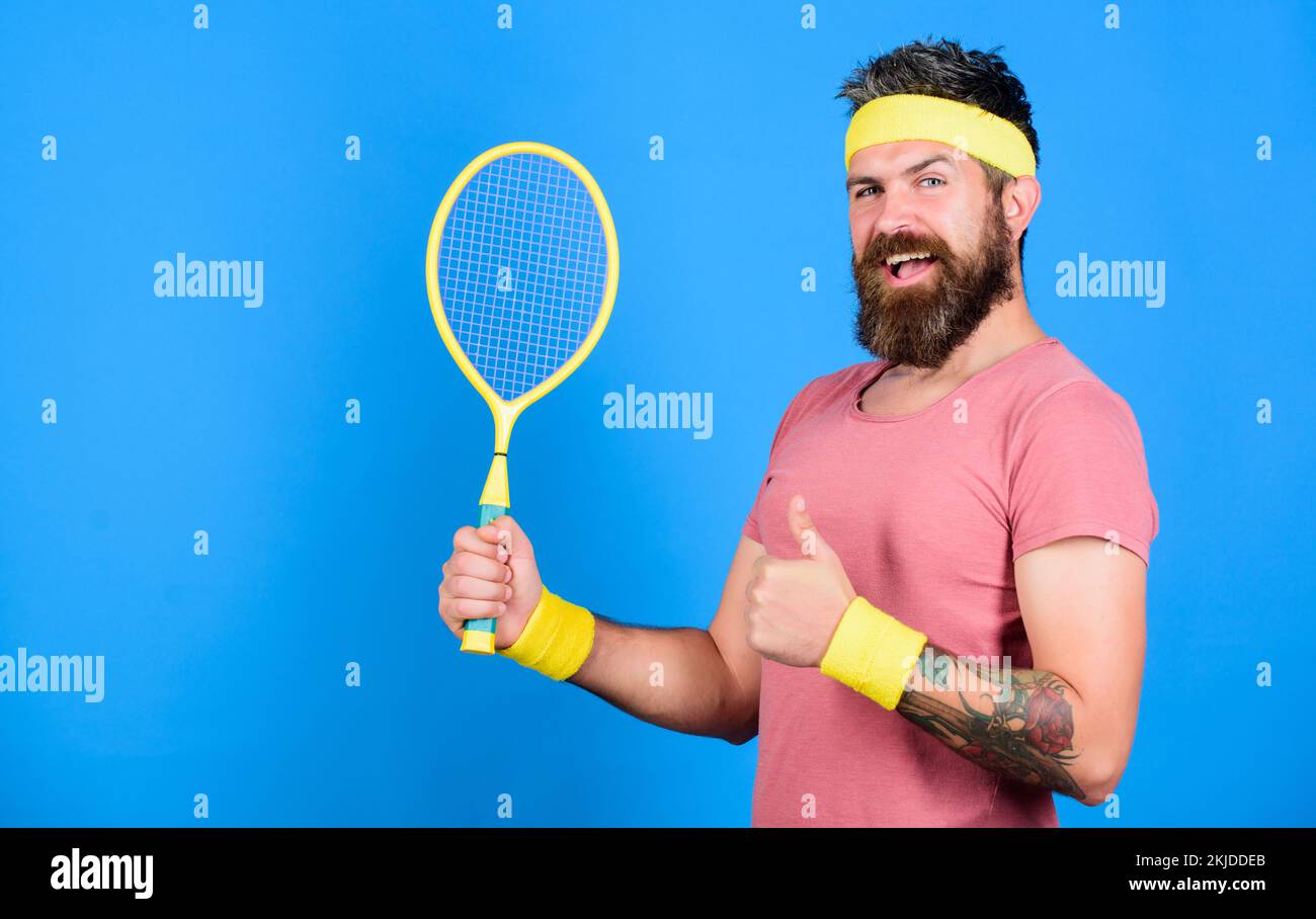 Athlete hold tennis racket in hand on blue background. Tennis sport and ...