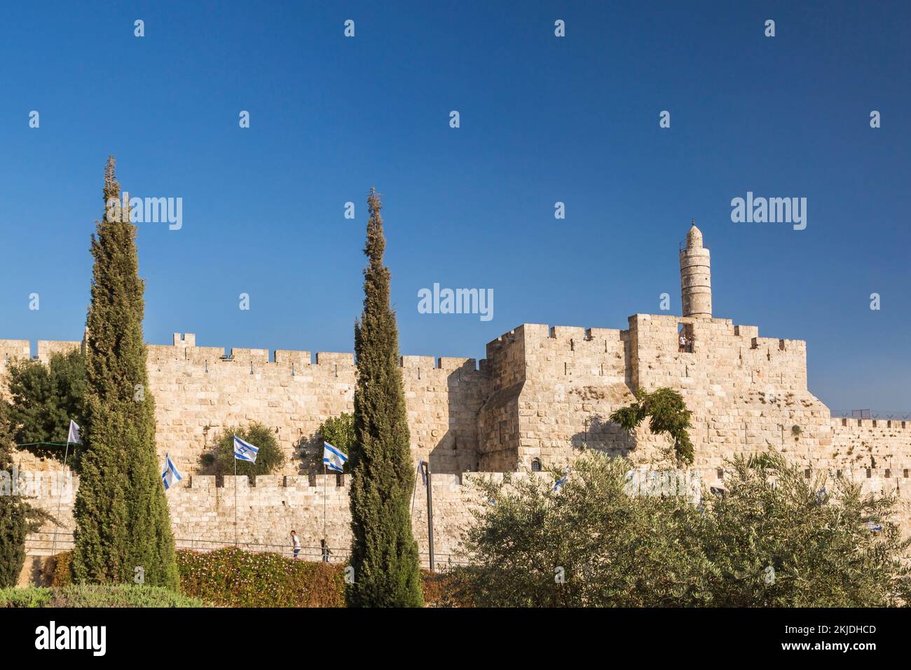 Tourists and local residents walking past the stone walls of the Old ...