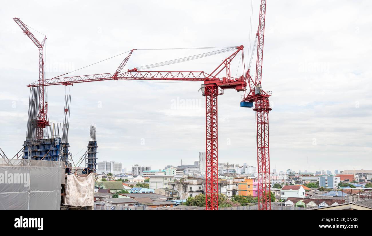 View of the construction site and red cranes for building modern ...