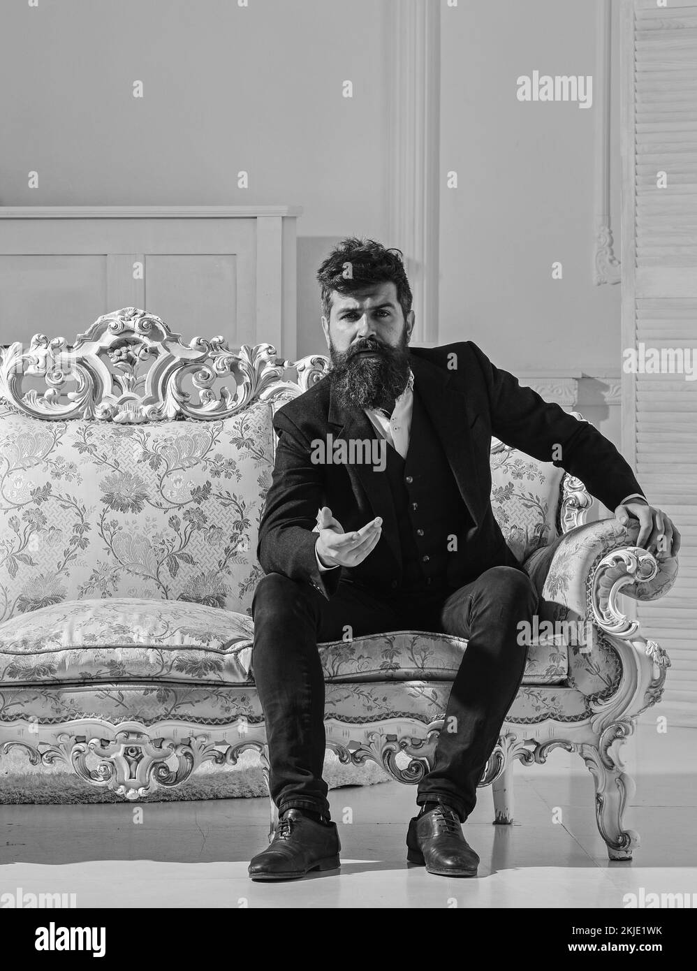 Man sits on sofa wearing Black and White Stock Photos & Images - Alamy