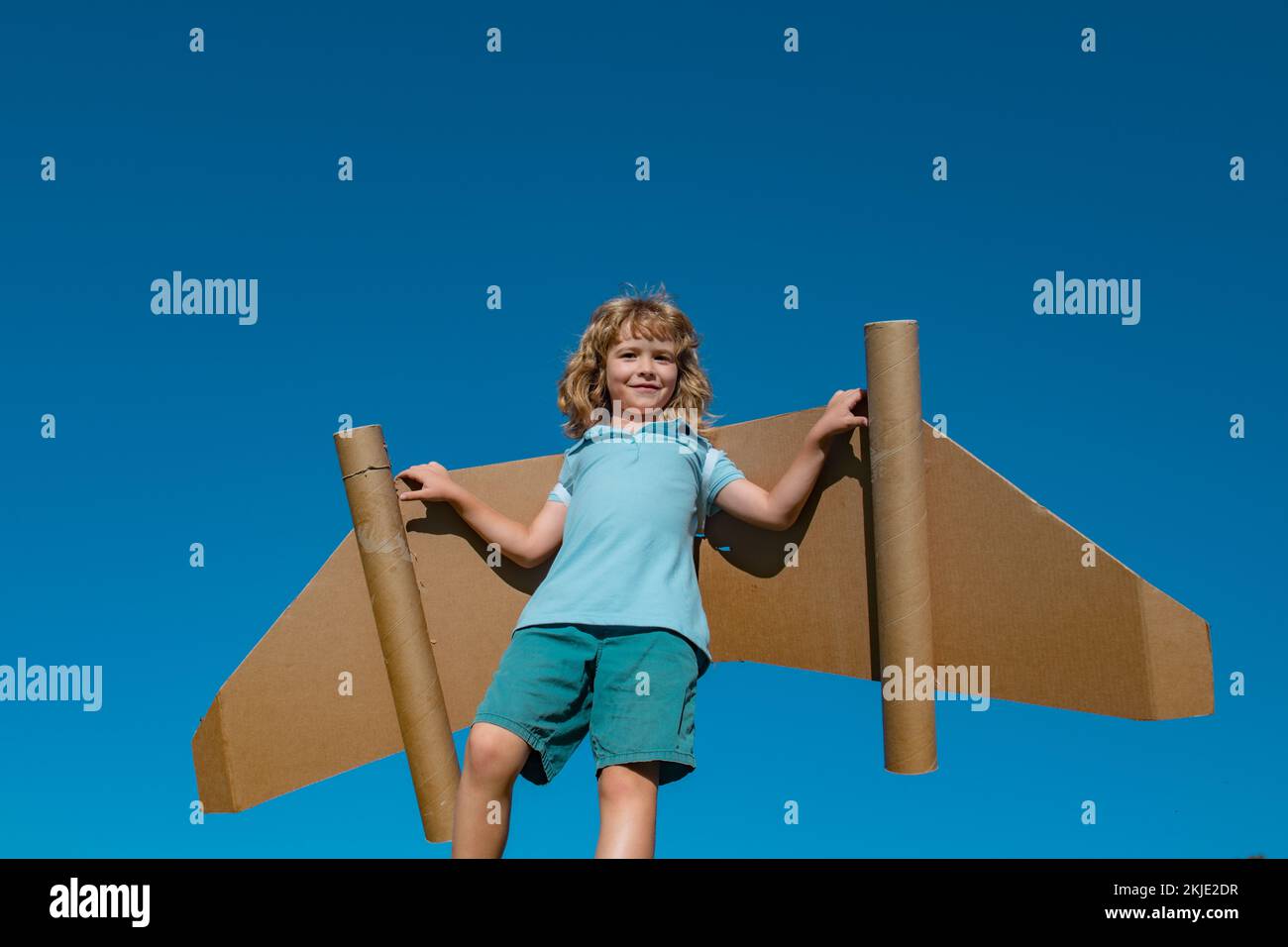 Happy child playing with toy jetpack. Kid pilot having fun on sky ...