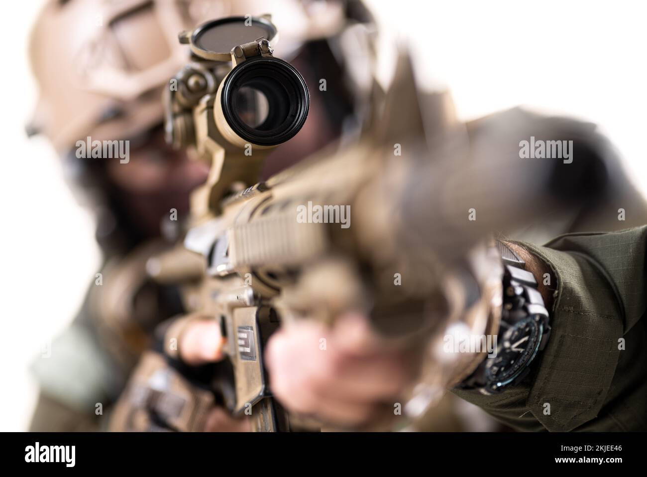 soldier fully equipped with tactical gear aiming at enemy with sniper ...