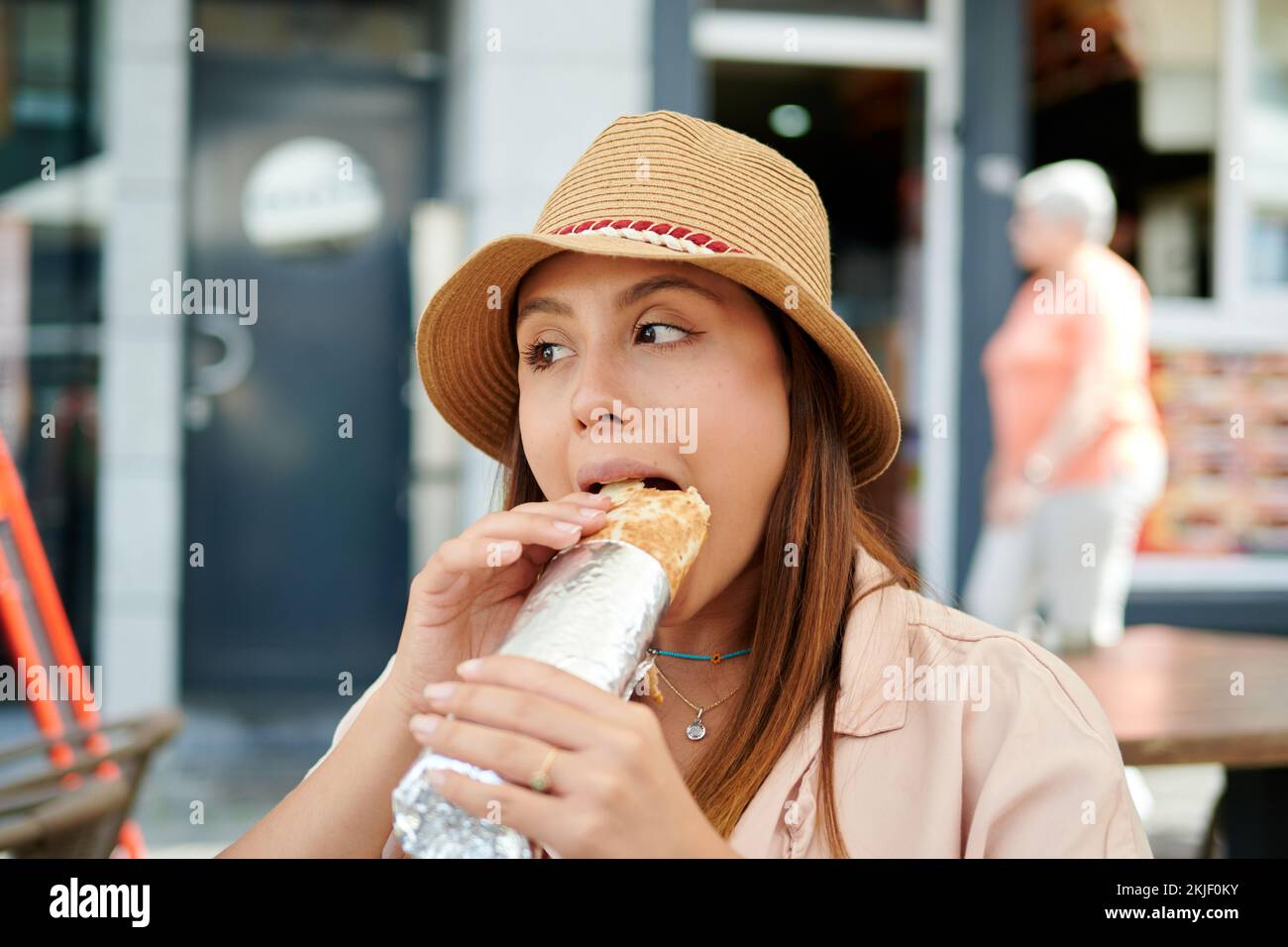 Girl woman eating a burrito hi-res stock photography and images - Alamy