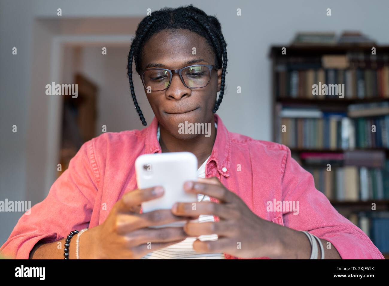 Shy introverted African American man chatting on phone flirting with ...