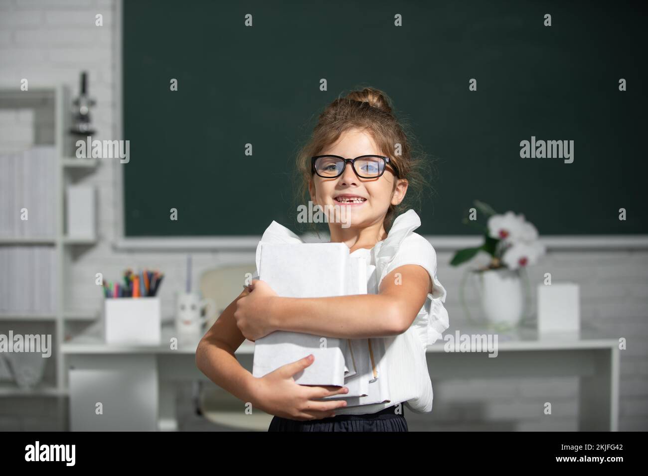 Back to school. Cute child nerd with books at school. Kid is learning ...