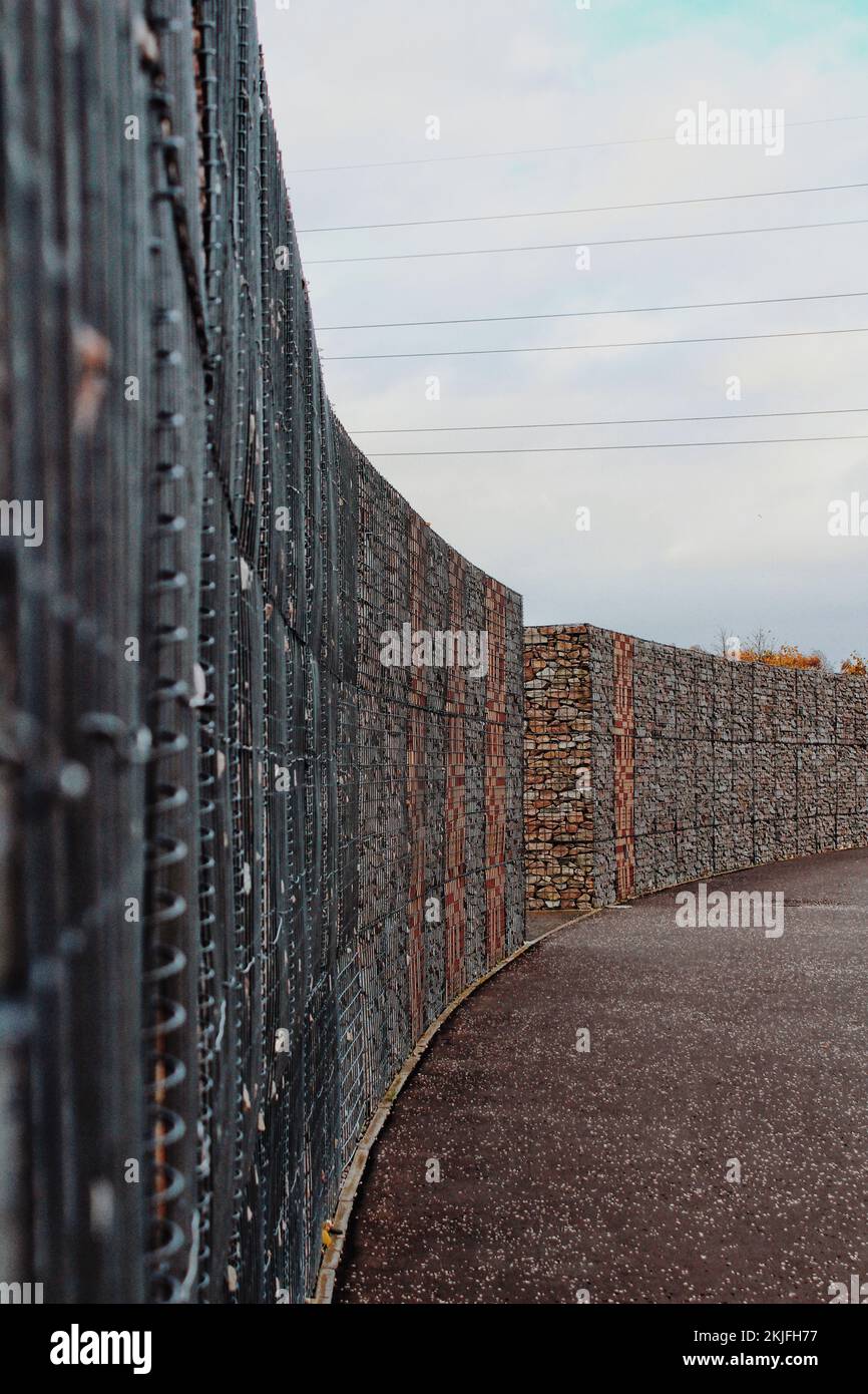 A perspective view on a gabion wall made of metal grid and gravel Stock ...