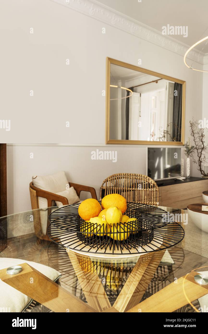 Round glass table and wooden legs with decorative black wire ...