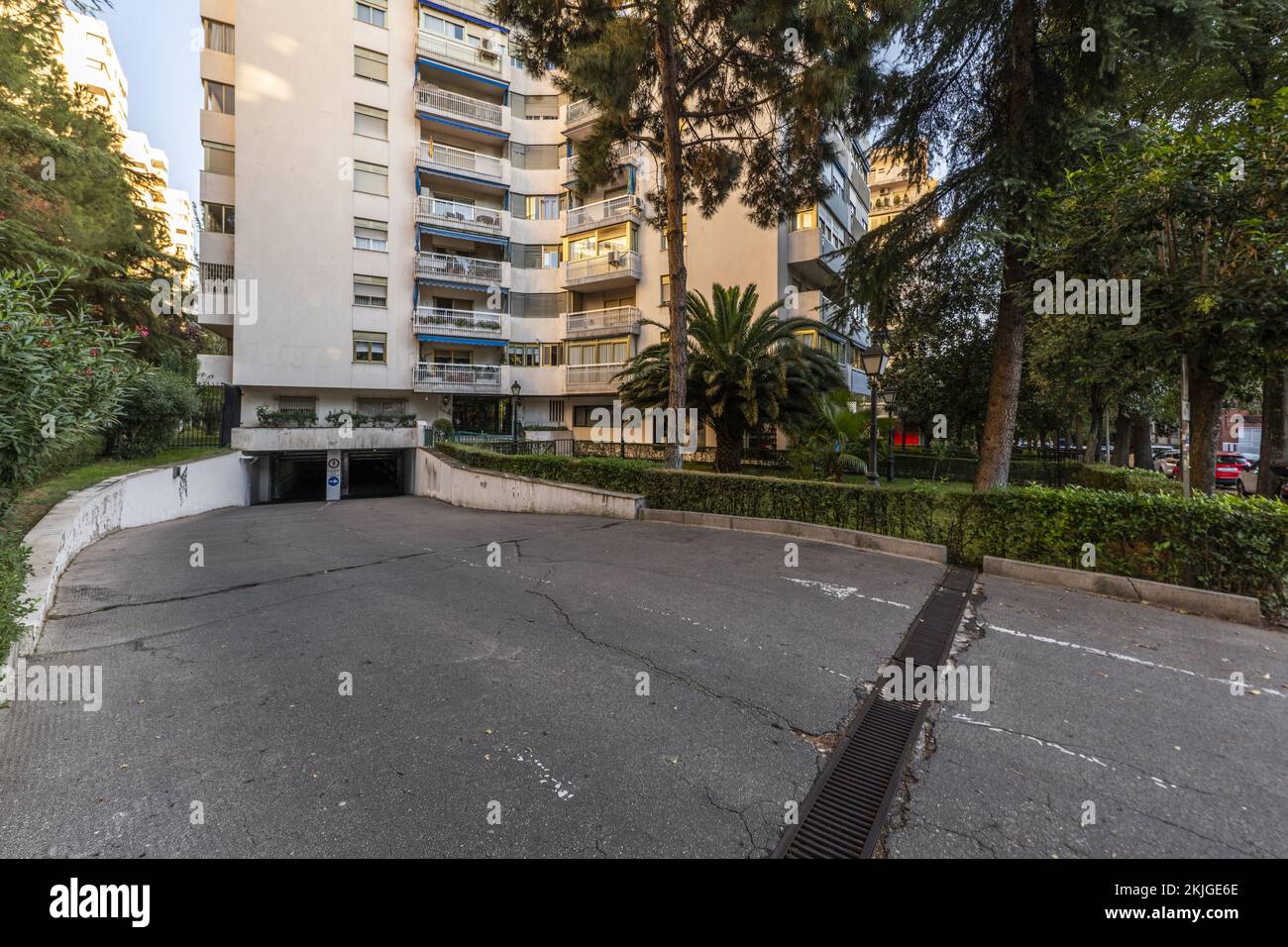 Asphalt access ramp to the garages of a residential housing building ...