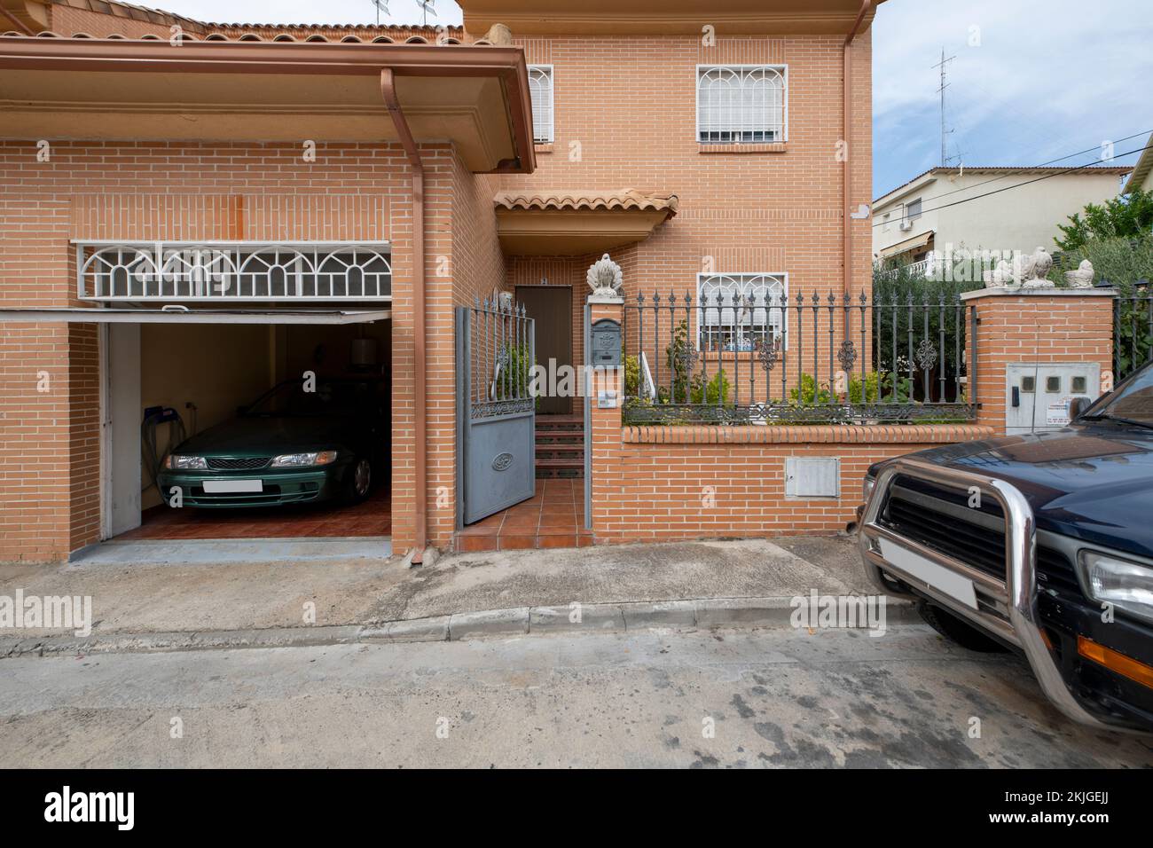 Exterior street of a country house with garage and metal fence Stock ...