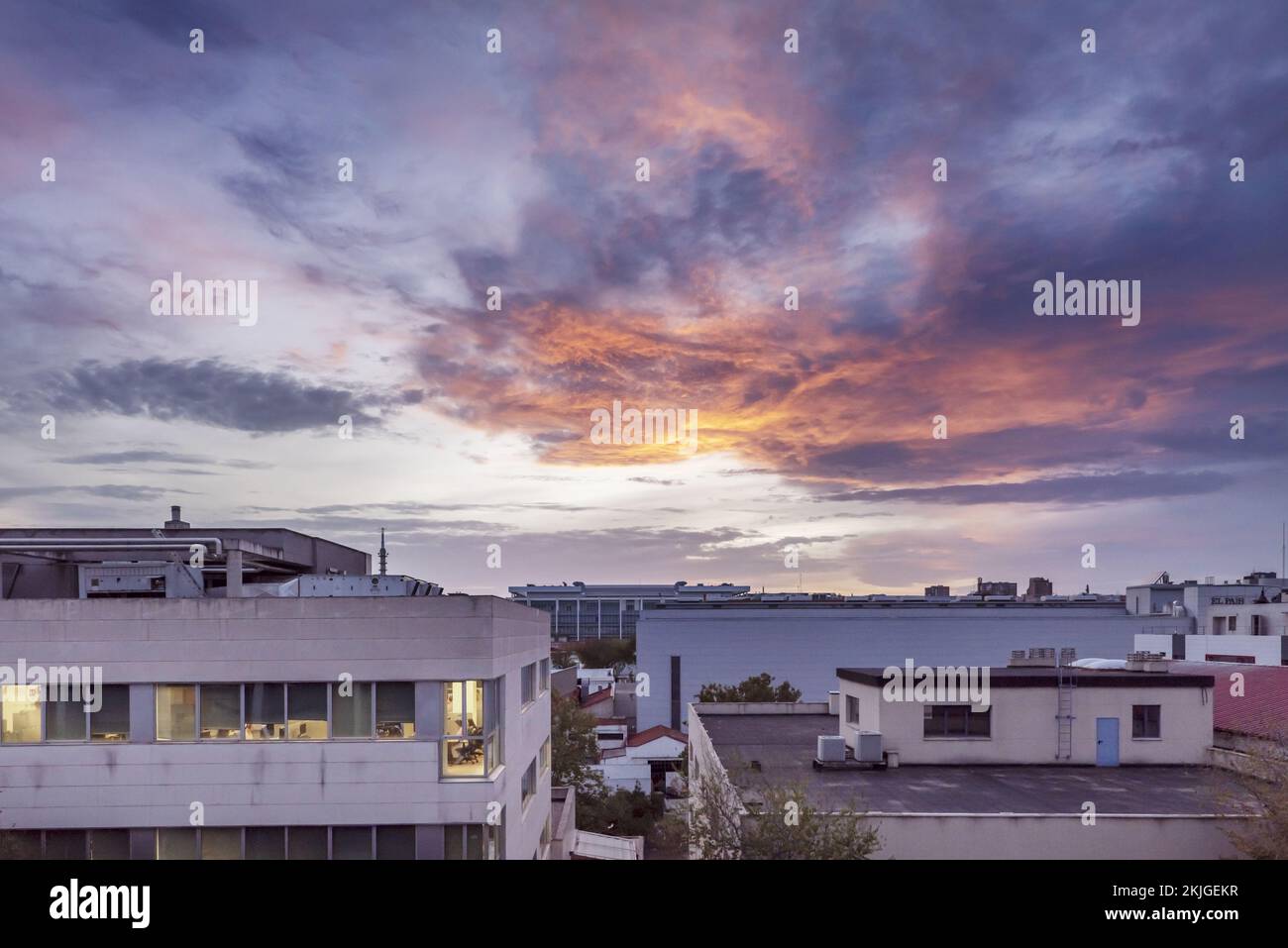 Rooftops of office buildings in a sunset with clouds Stock Photo - Alamy