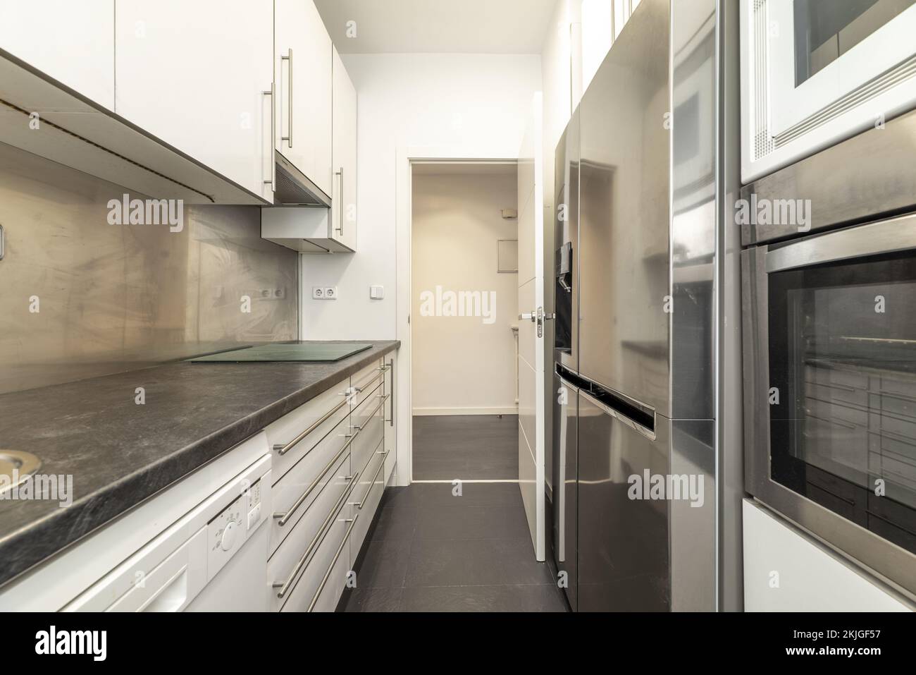 kitchen with white lacquered cabinets, gray wood countertops and built ...