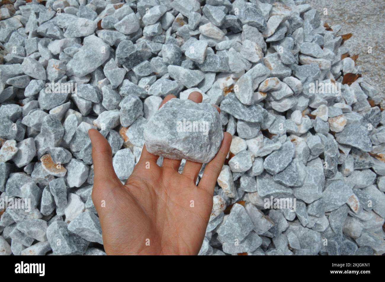 Hand holding little stone hi-res stock photography and images - Alamy