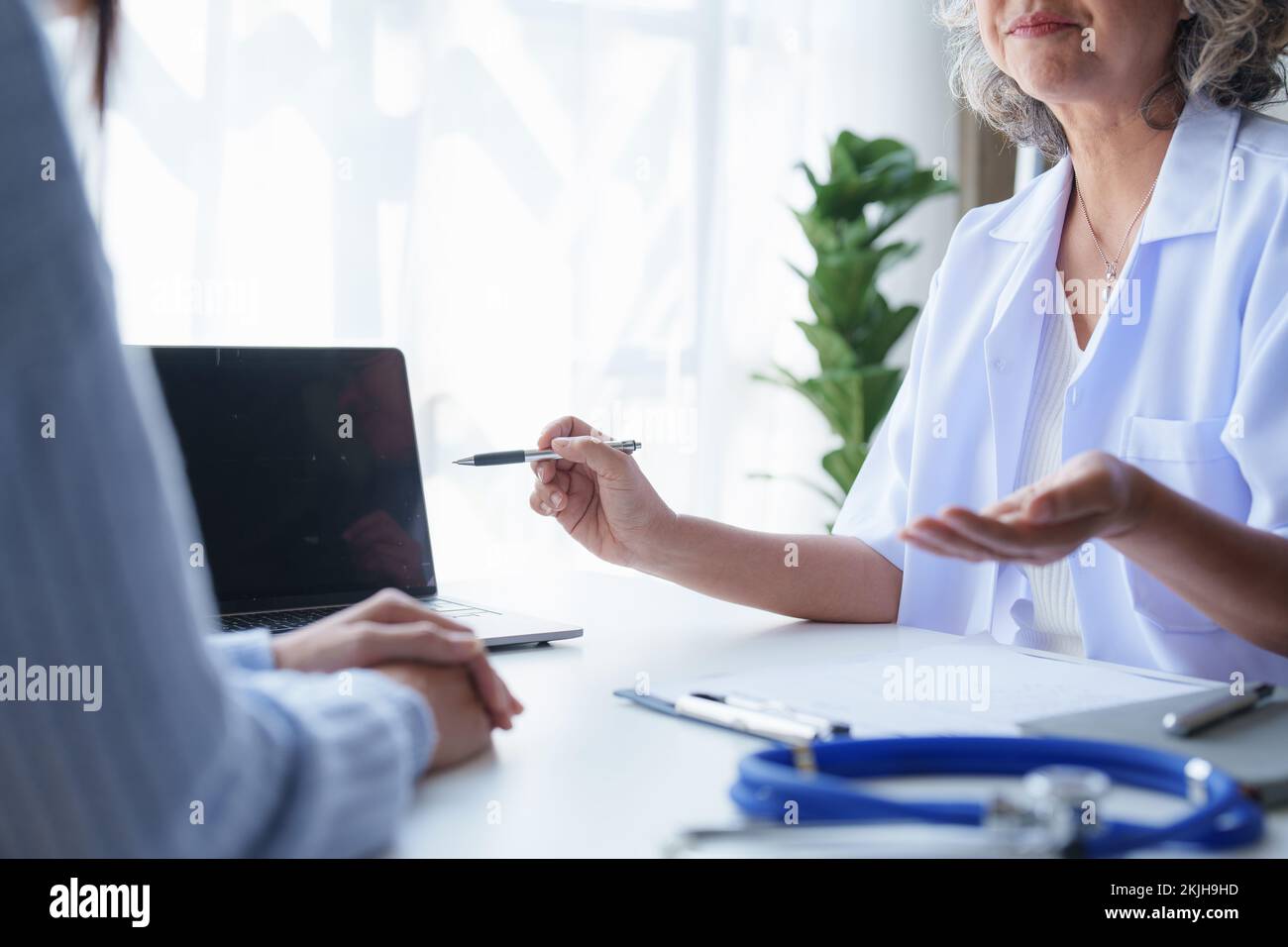 Doctor having conversation with patient while discussing explaining ...