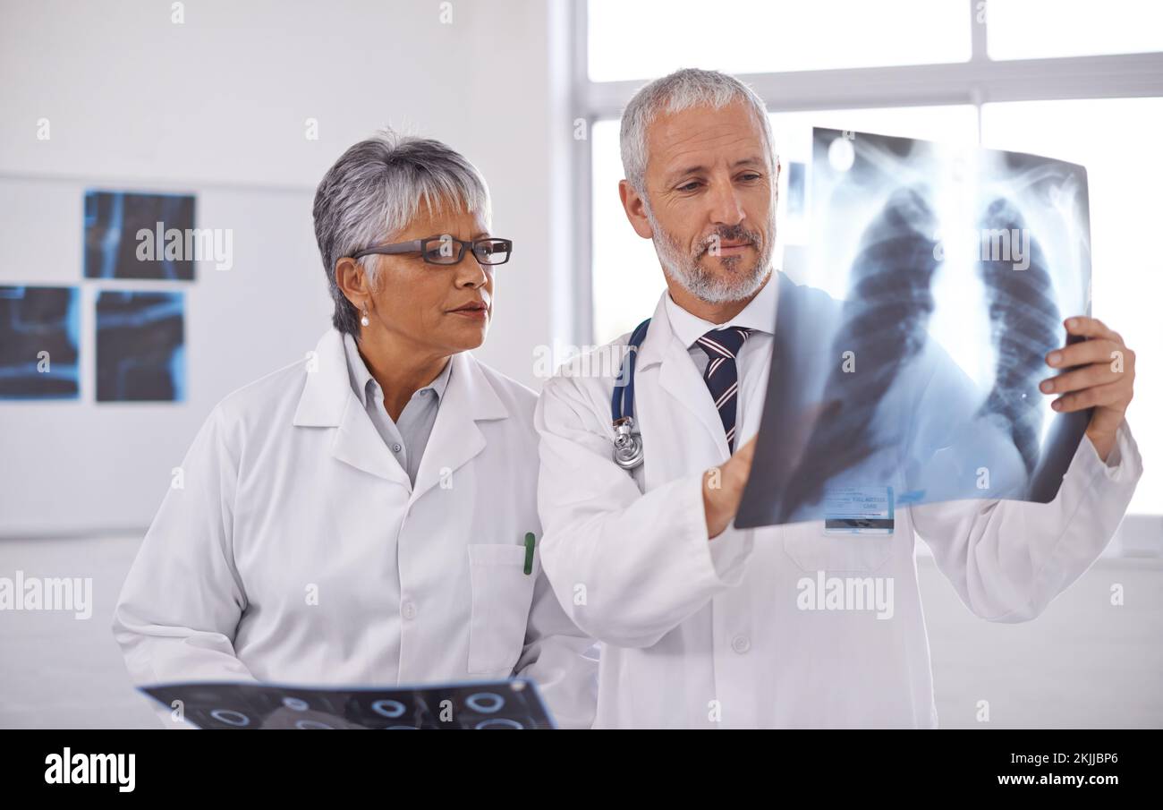 Consulting a colleague for a second opinion. two doctors working ...